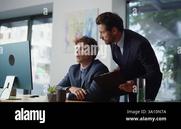 Serious mentor giving advice to manager in modern office. Focused ...