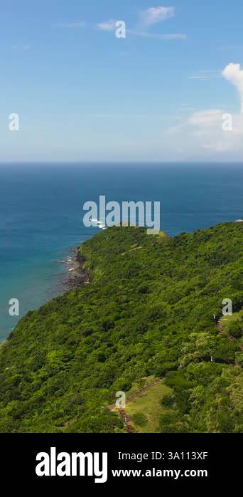 Lighthouse on a hill and blue ocean. Cape Engano. Palaui Island. Santa ...