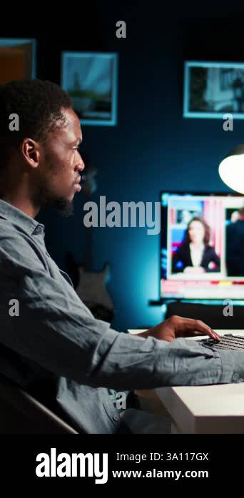 Vertical Video Young man video editor works on editing film footage at ...
