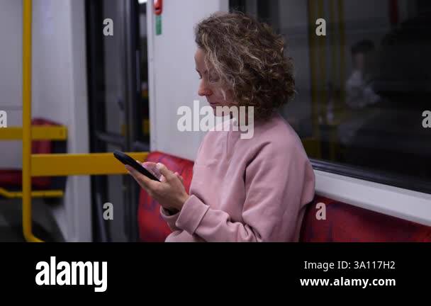 Urban commuter immersing herself in digital world, navigating subway ...