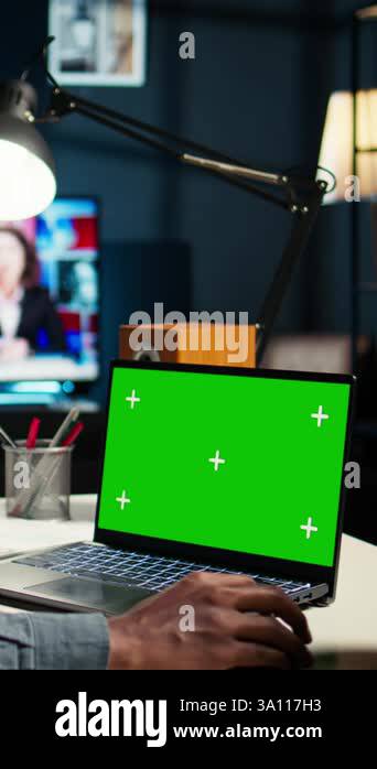 Vertical Video Teleworker at home editing documents next to mockup on his laptop, submitting ...