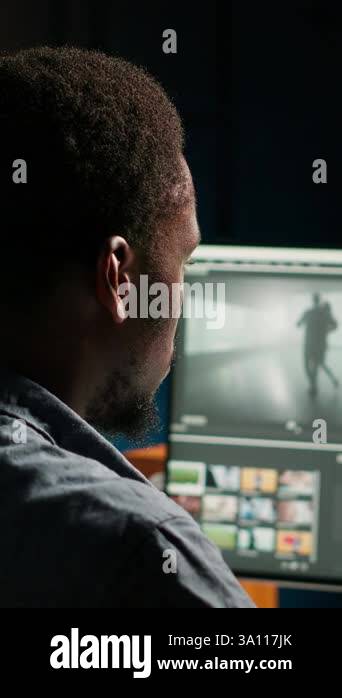 Vertical Video Young man video creator working on editing a movie ...