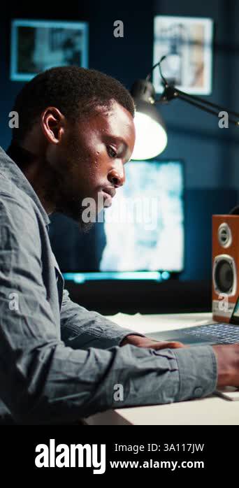 Vertical Video Self employed Black man multitasking at home taking ...