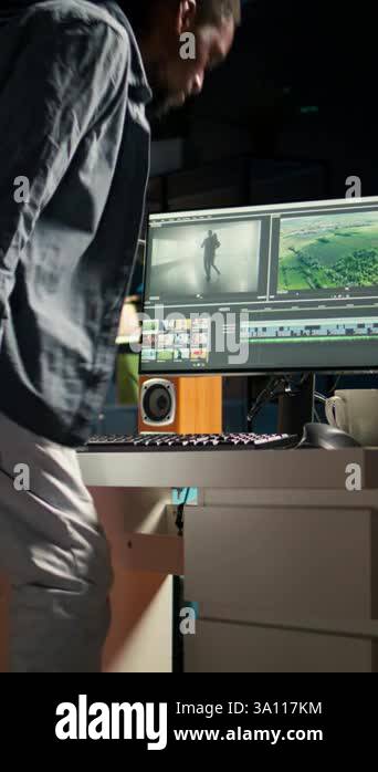 Vertical Video Male video editor working on creative software to create ...