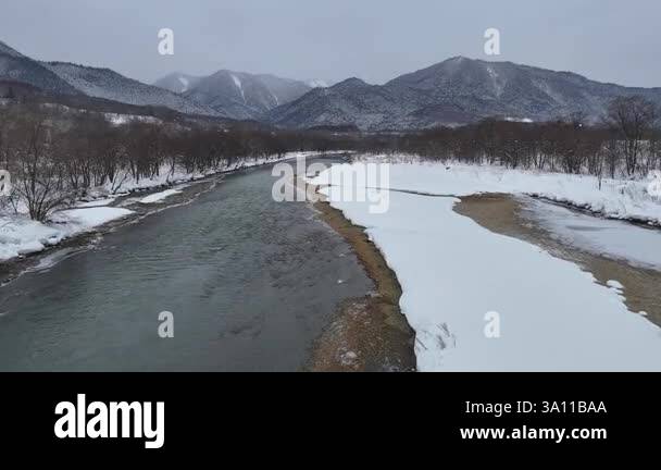 4K Aerial view of Sorachi river winter weather in Furano, Japan Stock ...