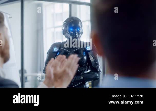 In a modern office, a man converses with a robot, demonstrating ...