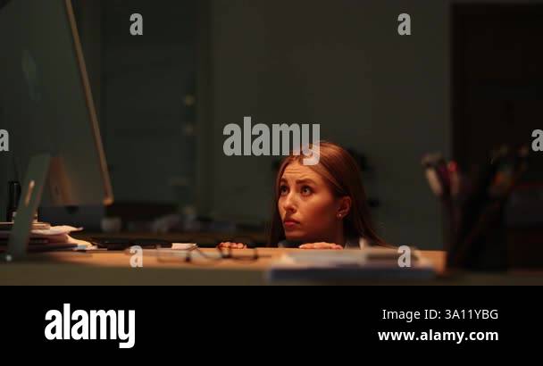 Frightened woman secretary crouches near office desk. Scared office ...