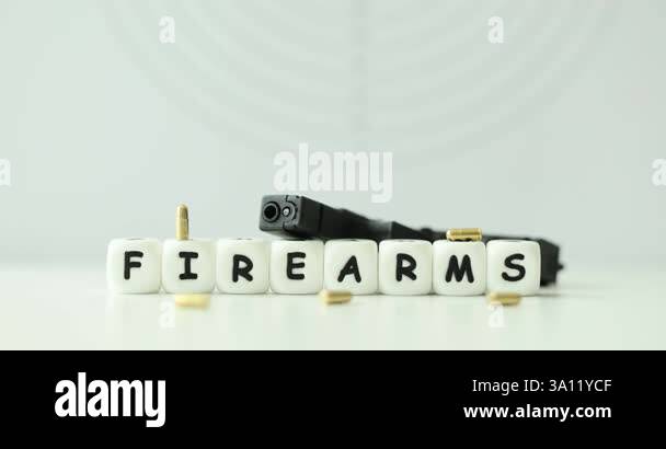 Word Firearms on small blocks with bullets and handgun in white space ...