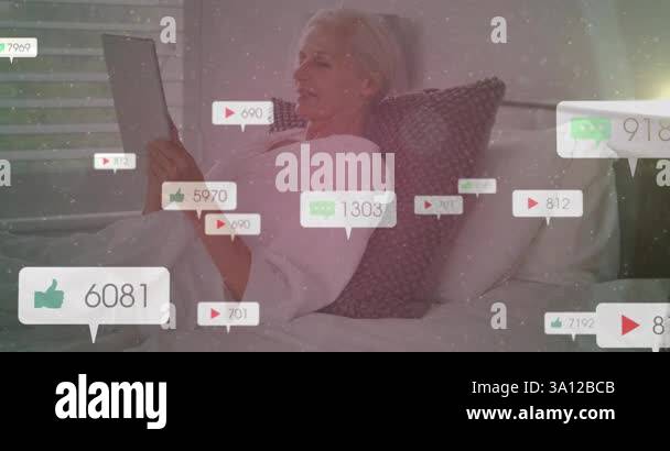 Using tablet, elderly woman receiving social media notifications in ...