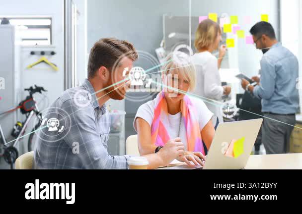 Collaborating at desk, business professionals with digital network ...