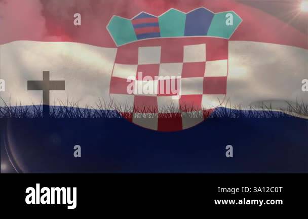 Waving Croatian flag with cross silhouette in foreground, grass swaying ...