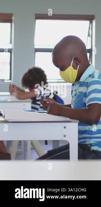 Animation of falling letters and icons over diverse pupils in classroom ...