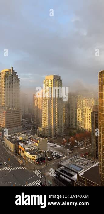 A thick mist envelops the towering skyscrapers in a tranquil urban ...