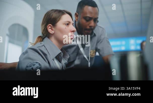 Airport Security Checkpoint: Two Diverse TSA Workers Monitoring Baggage ...