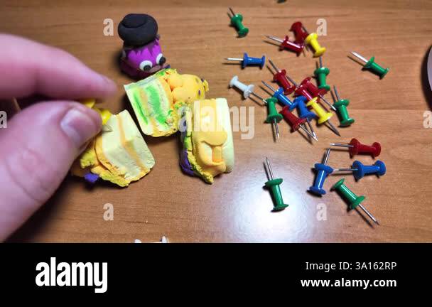 Push pins on the table slow motion video. Colorful push pins falling ...