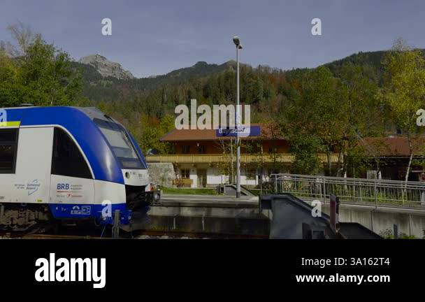 In Bayrischzell, Bavaria, a train halts at its alpine terminus, framed ...