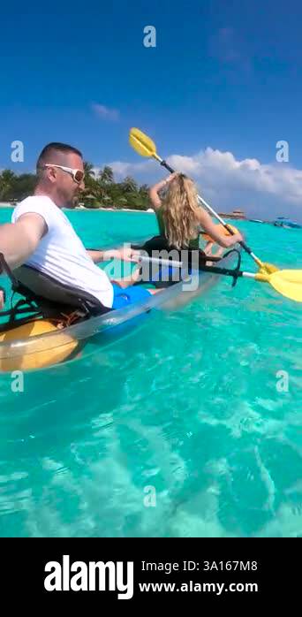 Two people transparent kayak in the clear turquoise waters of the ...