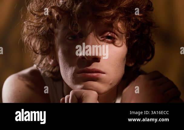 Close-up portrait of red-haired Caucasian gen Z man posing for camera ...