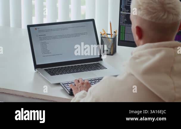 Over the shoulder view of male developer sitting in front of wireless ...