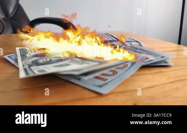 Fire Burning One Hundred Dollar Bills on a Wooden Table, Symbolizing ...