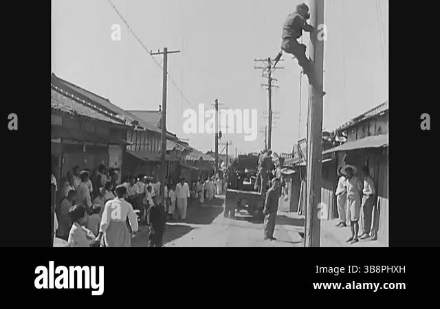 CHINJU - 1950 - A 25th Signal Corps soldier on a pole strings up ...