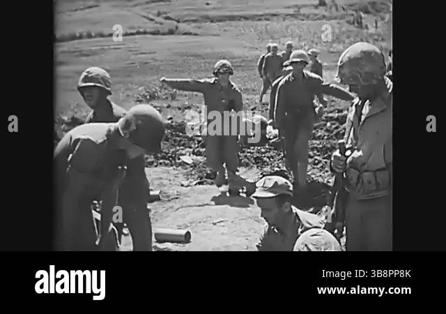 OKINAWA - 1945 - US Marines carry a wounded soldier on a stretcher to a ...