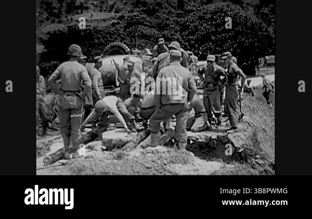 OKINAWA - 1945 - Engineers build a temporary bridge across a large ...