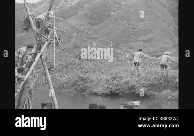 HAWAII - 1945 - Members of USO troupe cross rope bridge at the Jungle ...
