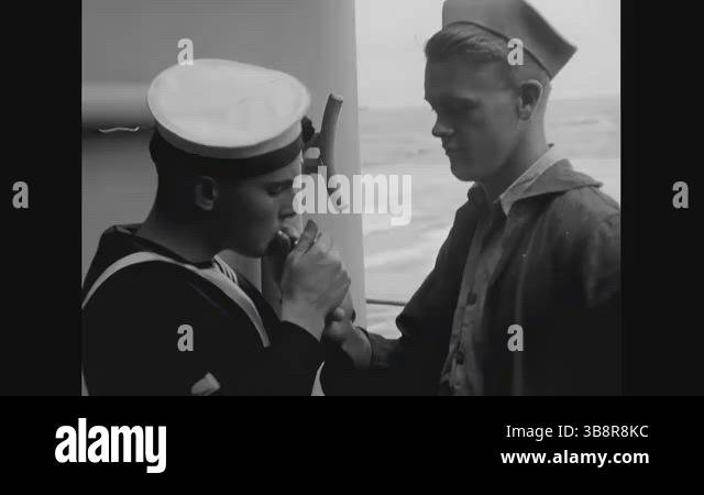 PACIFIC OCEAN - 1945 - Two young officers smoke while aboard the USS ...