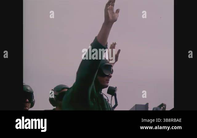 USA - 1969 - A US Navy deck hand signals to an RA-5C as it is loaded ...