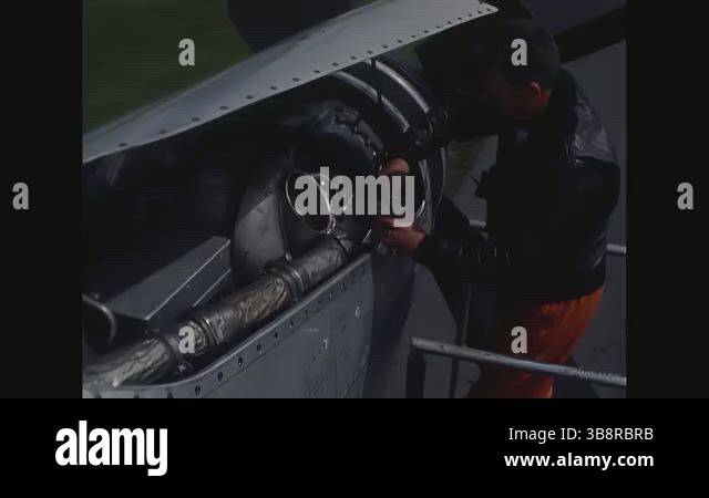CAPE TOWN - 1963 - A US Navy flight engineer checks the oil stick of an ...