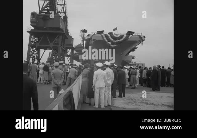 USA - 1956 - Officers and a bustling crowd arrive to celebrate the ...
