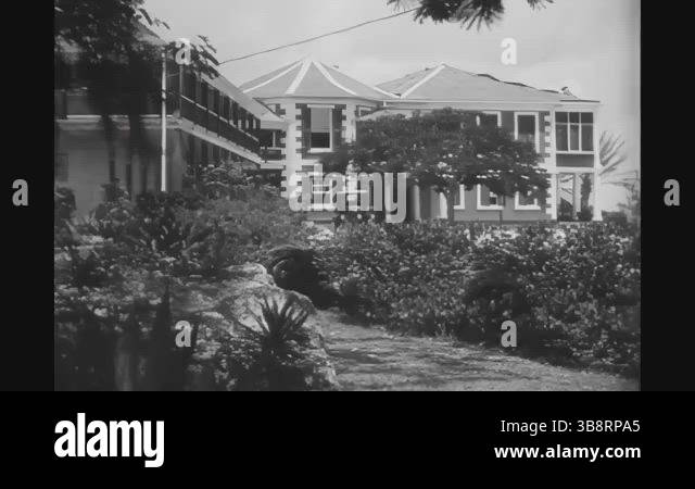 BAHAMAS - 1920 - An ornamental gate welcomes visitors as pedestrian and ...
