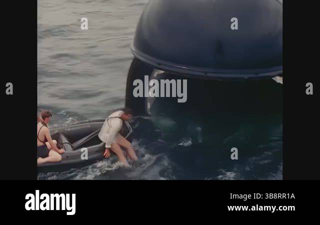 USA - 1970 - Divers arrive by boat and enter the Amphibious Transport Submarine USS Grayback ...