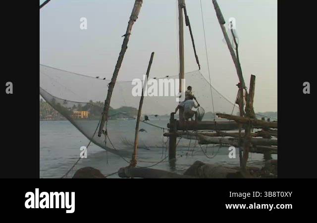 INDIA - 1999 - A pulley system is used to lower a large fishing net ...