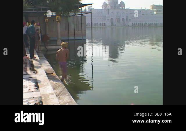 INDIA - 1999 - A Sikh man wades into the sacred pool outside India's ...