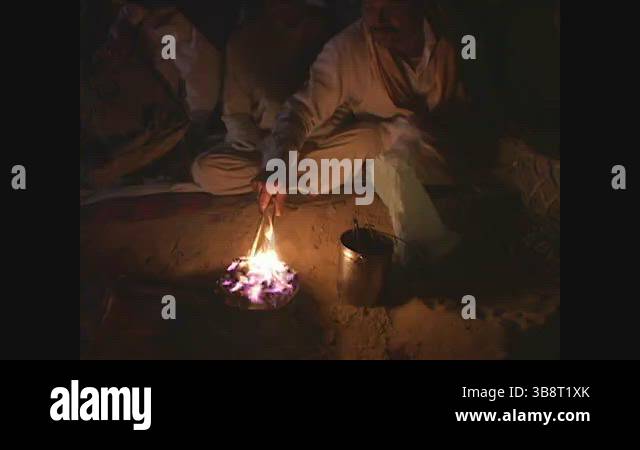 INDIA - 1999 - A fire eater is handed embers straight from the fire and ...
