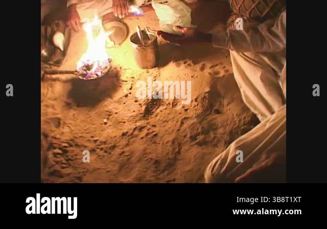 INDIA - 1999 - A fire eater is handed embers straight from the fire and ...