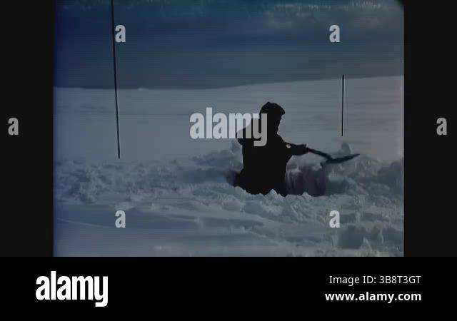 ANTARCTICA - 1959 - Men are digging a hole in the snow for explosives ...