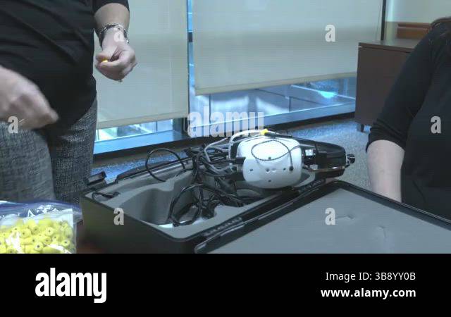 BETHESDA - 10.25.2023 - A woman provides headphones and ear plugs to ...