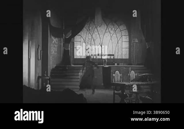 US - 1924 - in this silent western, a man swings back and forth on a curtain, avoiding his ...