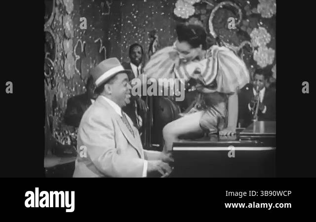 USA - 1941 - Showgirls dance at a nightclub as Fats Waller's band plays ...