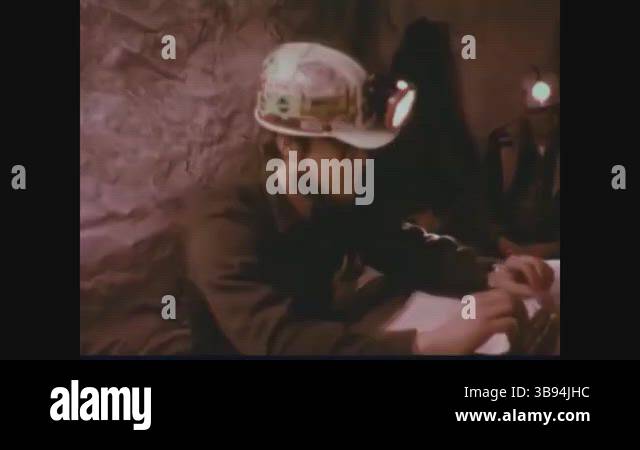 USA - 1970s - Several coal miners discuss safety measures in the mine ...
