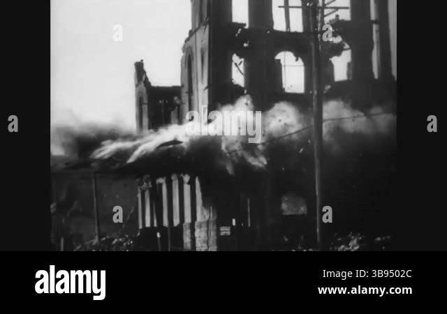 TORONTO - 1904 - A wall crumbles down a smoldering building after fire ...