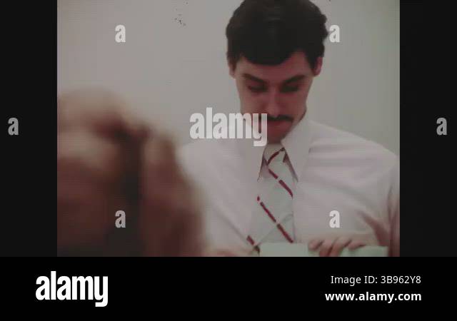 CHICAGO - 1977 - Office workers work inside offices and take elevators ...