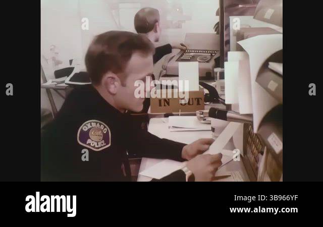 USA - 1976 - A police dispatcher sends messages to squad cars about an ...