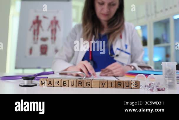 A medical professional examines samples related to Marburg Virus in a ...