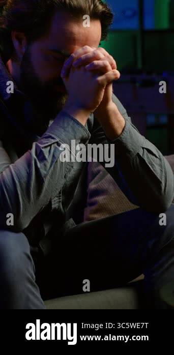 Vertical video Upset supporter watching sports match on live television ...