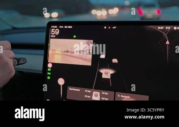Woman driving Tesla Model 3 with autopilot engaged, side camera view ...