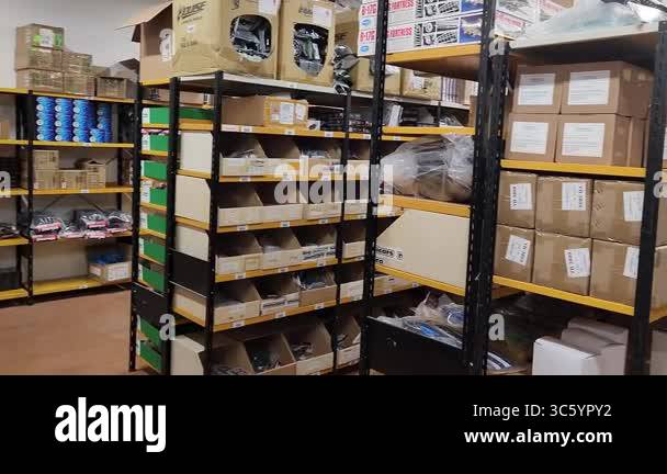 Warehouse with labeled storage boxes and shelves filled with various ...